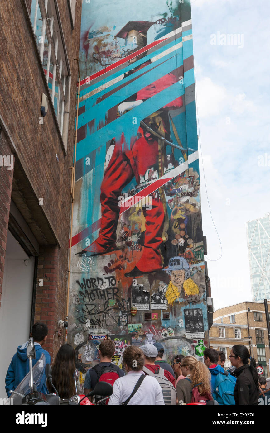 People looking up at a piece of street art Stock Photo - Alamy