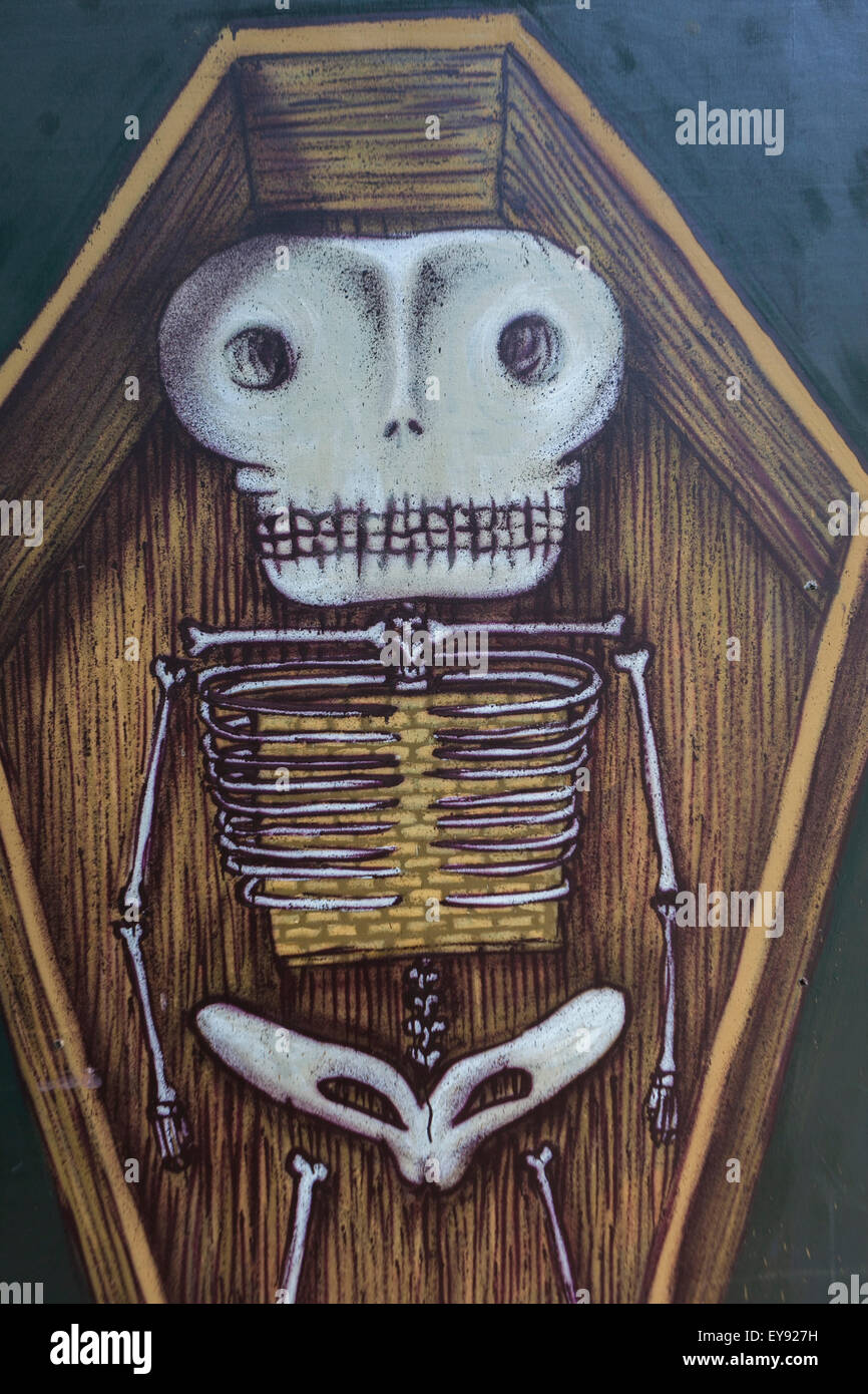 Skeleton in coffin, street art spray painted on construction site ...