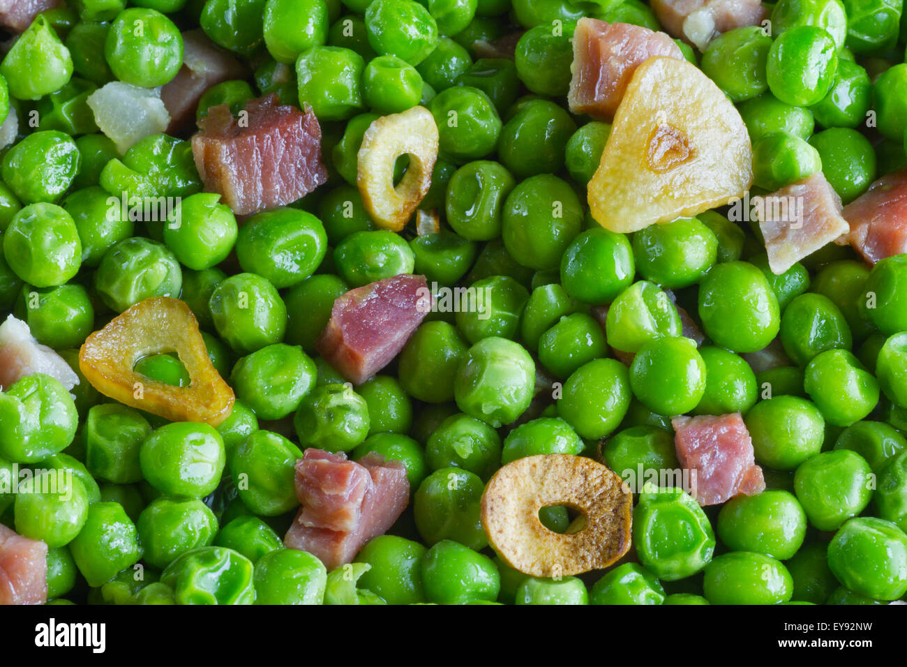 Peas with ham and garlic background Stock Photo - Alamy