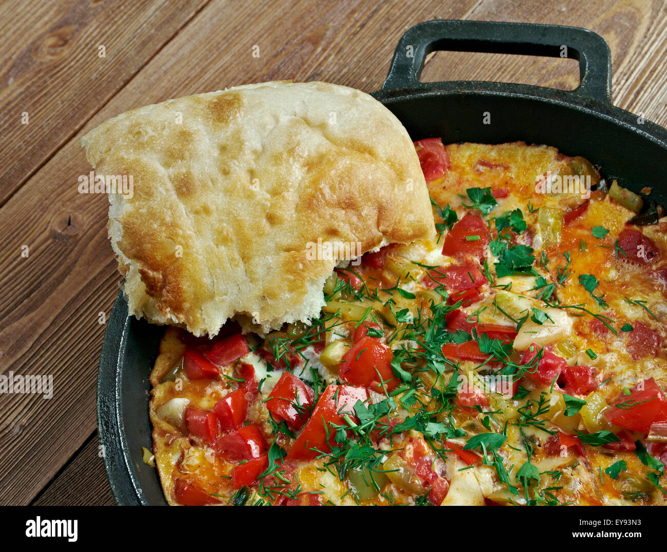 Menemen - traditional Turkish dish.includes eggs, onion, tomato, green ...