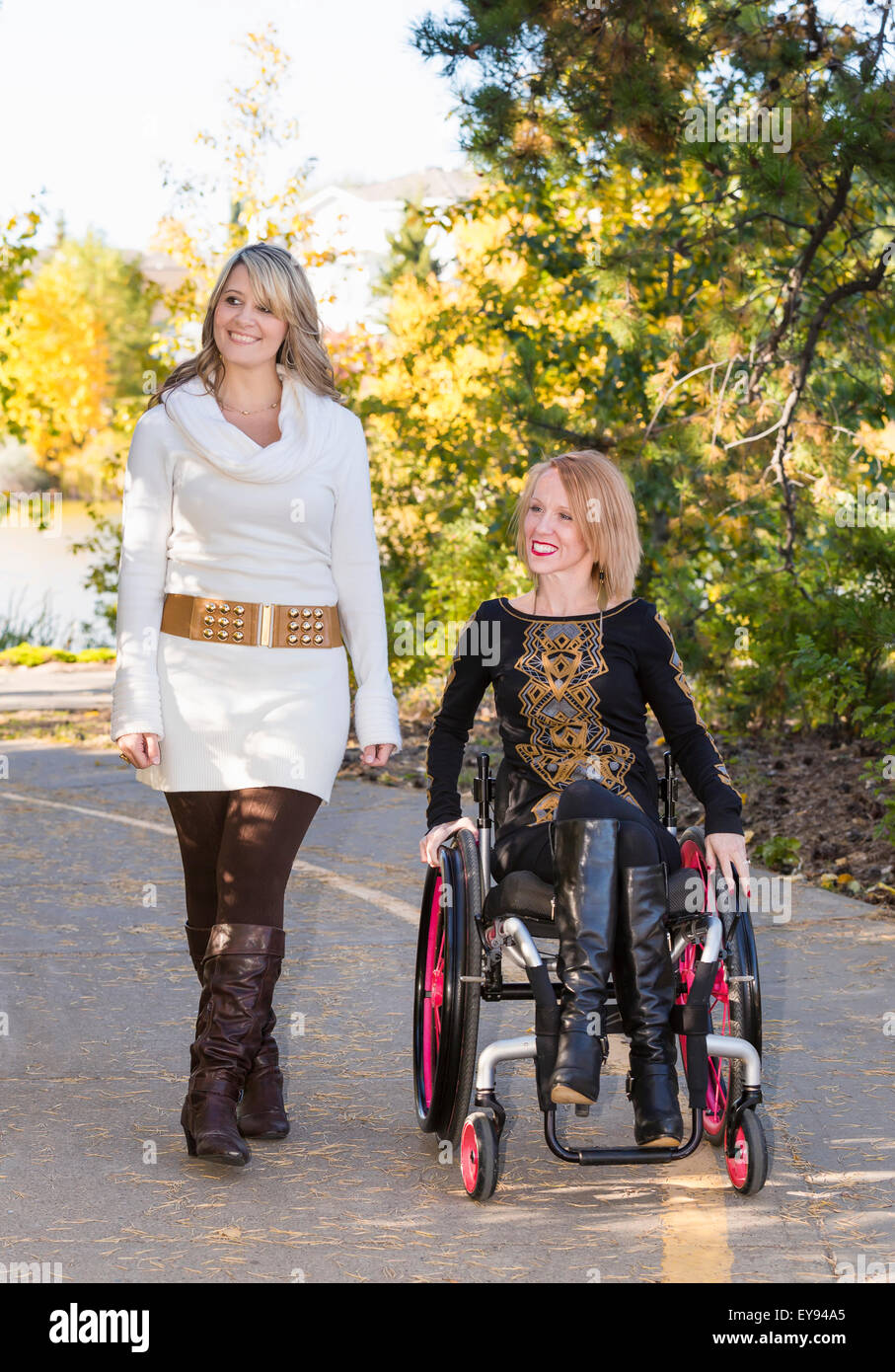 Young paraplegic woman and her friend spending quality time together in ...