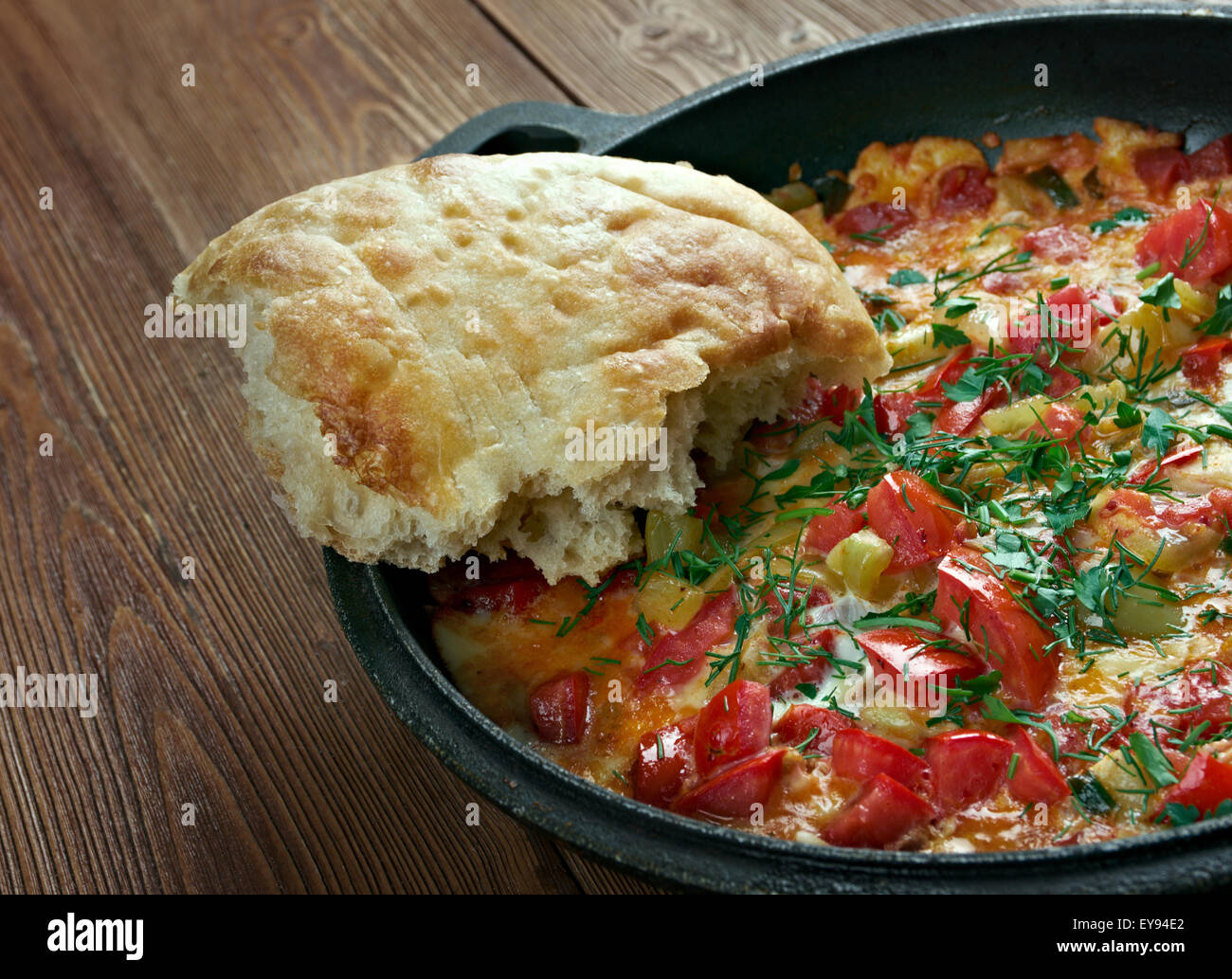 Menemen - traditional Turkish dish.includes eggs, onion, tomato, green ...