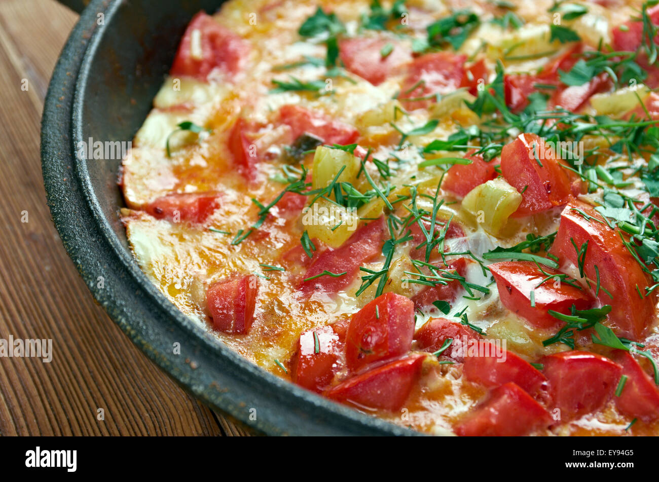 Menemen - traditional Turkish dish.includes eggs, onion, tomato, green ...