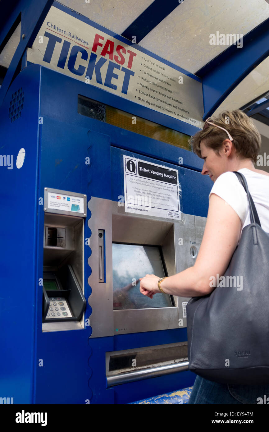 A young woman using a Fast Ticket machine at Warwick train station ...