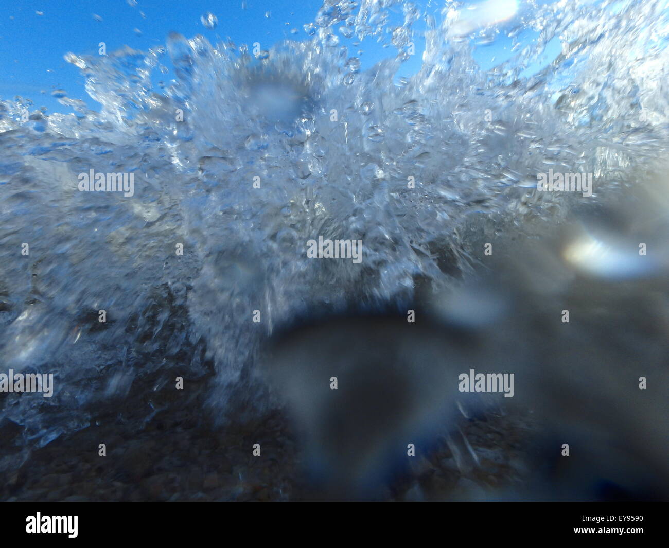 Small waves splashing in shallow waters at sunset Stock Photo - Alamy