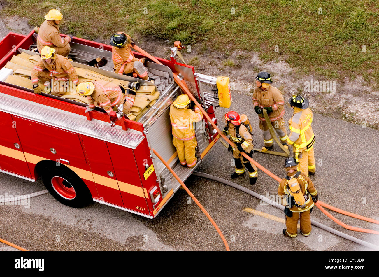 View from above of firefighters and their fire truck, as they work with ...