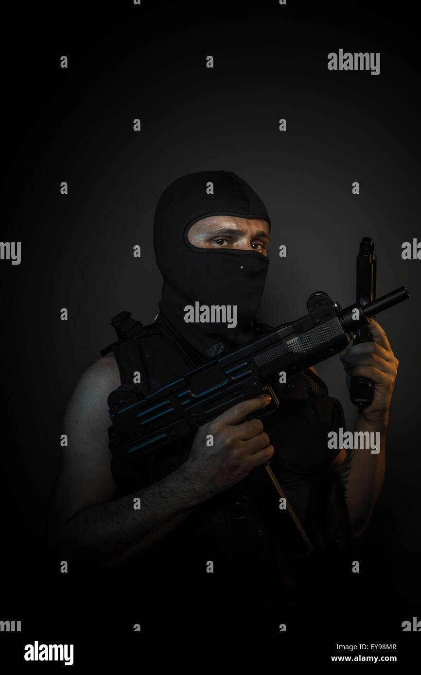 Robber, Man wearing balaclavas and bulletproof vest with firearms Stock ...