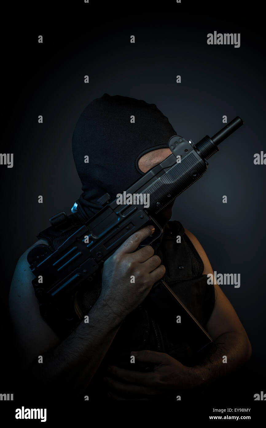 Criminal, Man wearing balaclavas and bulletproof vest with firearms ...