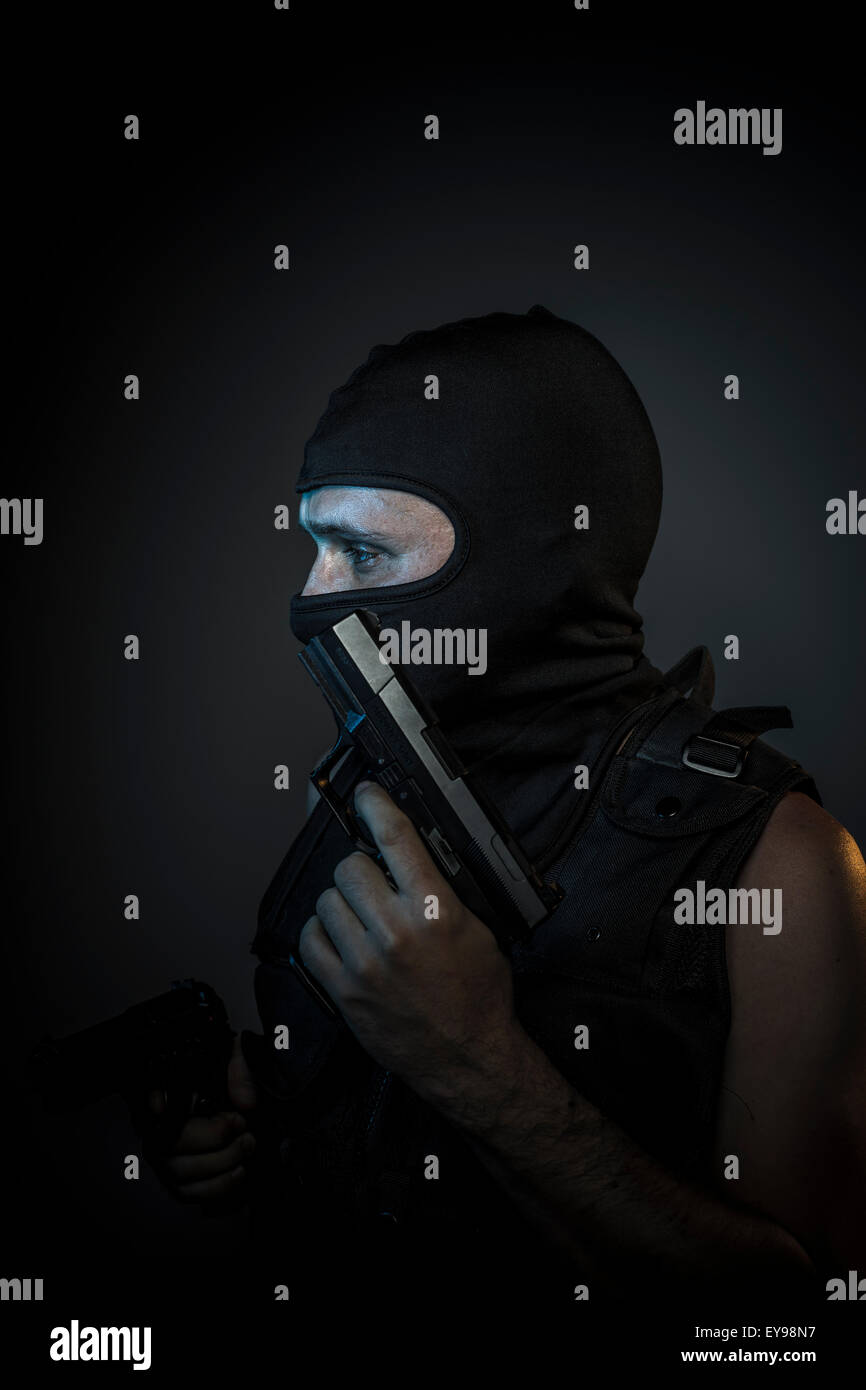 Man wearing balaclavas and bulletproof vest with firearms Stock Photo ...