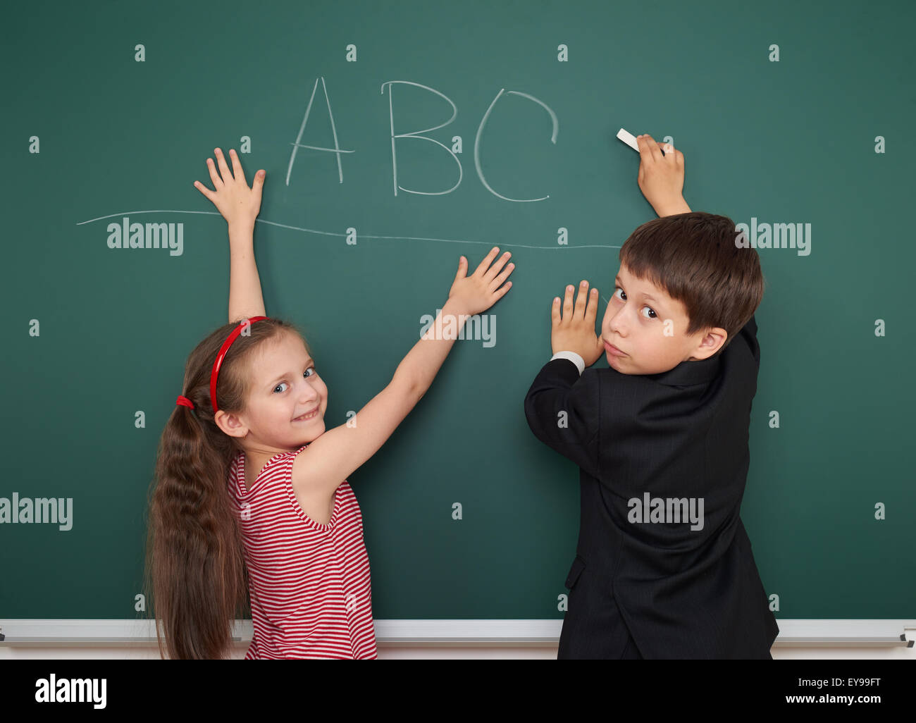 boy and girl write abc on school board Stock Photo - Alamy