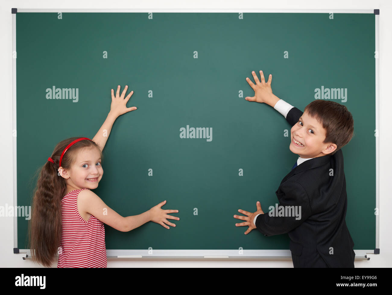 boy and girl write on school board Stock Photo - Alamy