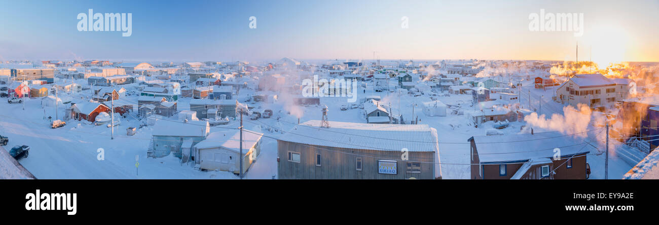Billowing chimneys of downtown Barrow are silhouetted during sunset ...