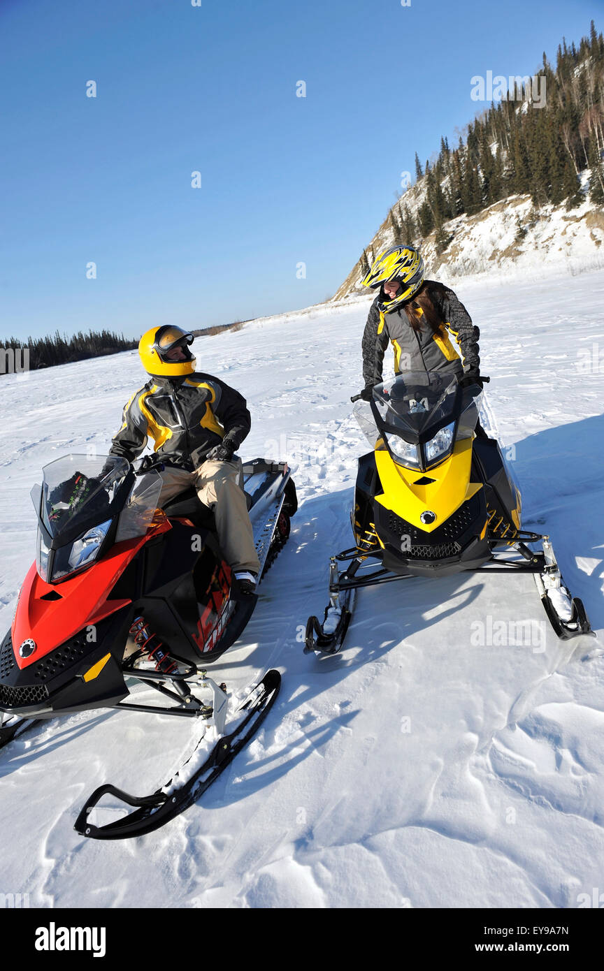 Two friends snowmachine near the Delta River north of the Alaska Range ...