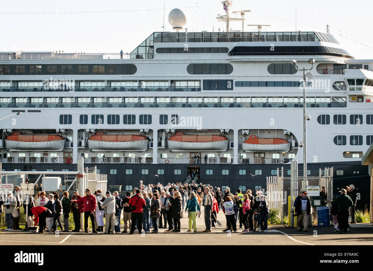 Tourists disembark a Holland America cruise ship at the Homer dock ...