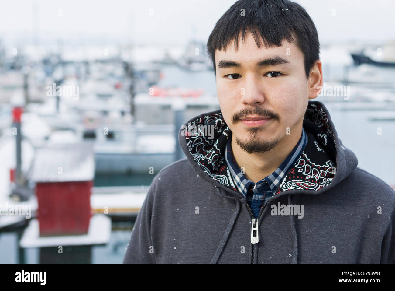 Portrait of an Alaskan native man in front of the Homer small boat ...
