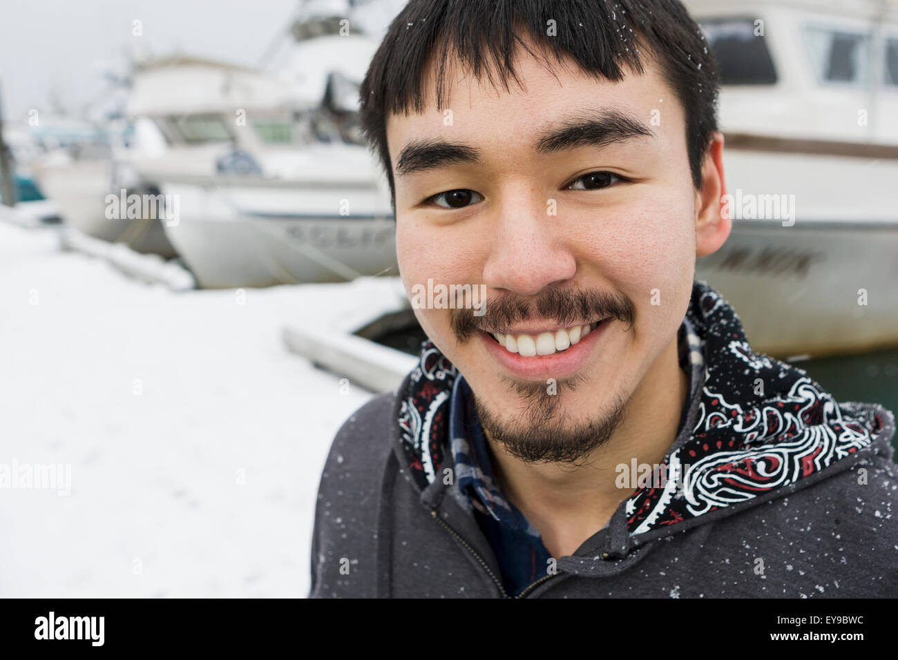 Portrait of an Alaskan native man in front of the Homer small boat ...