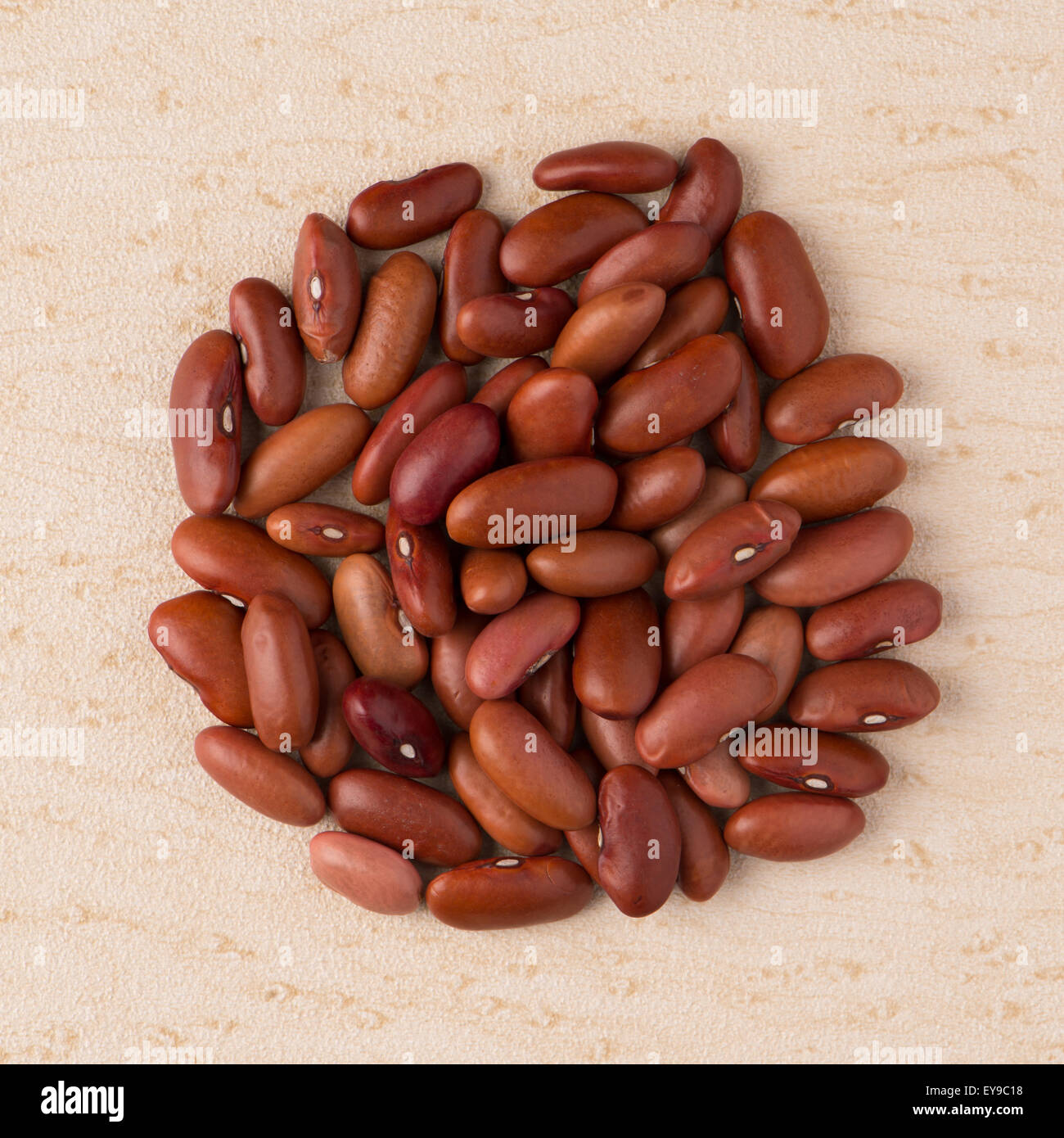 Circle of red beans on beige vinyl background Stock Photo - Alamy