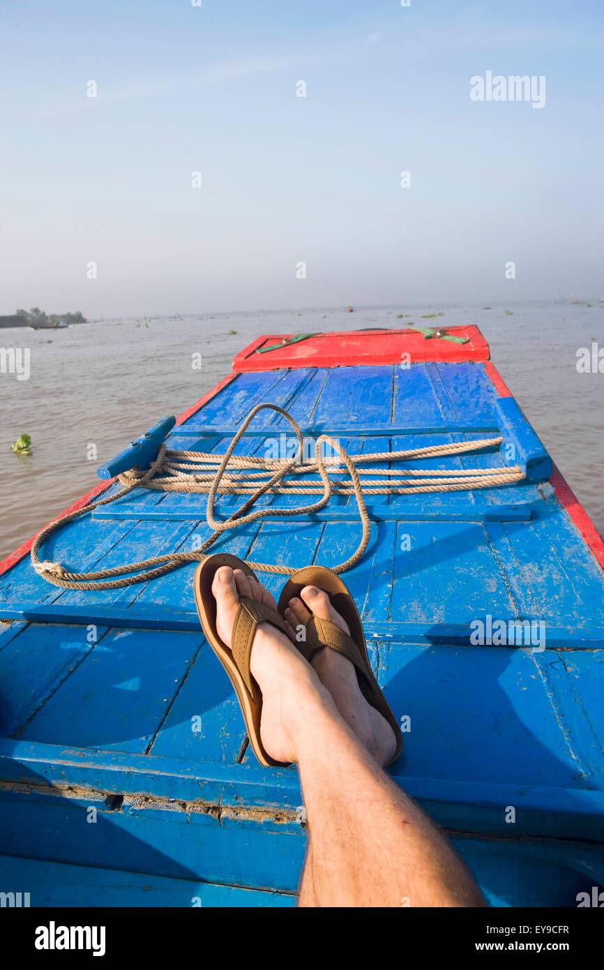 Persons Feet On Boat In Mekong Delta, Low Section Stock Photo - Alamy
