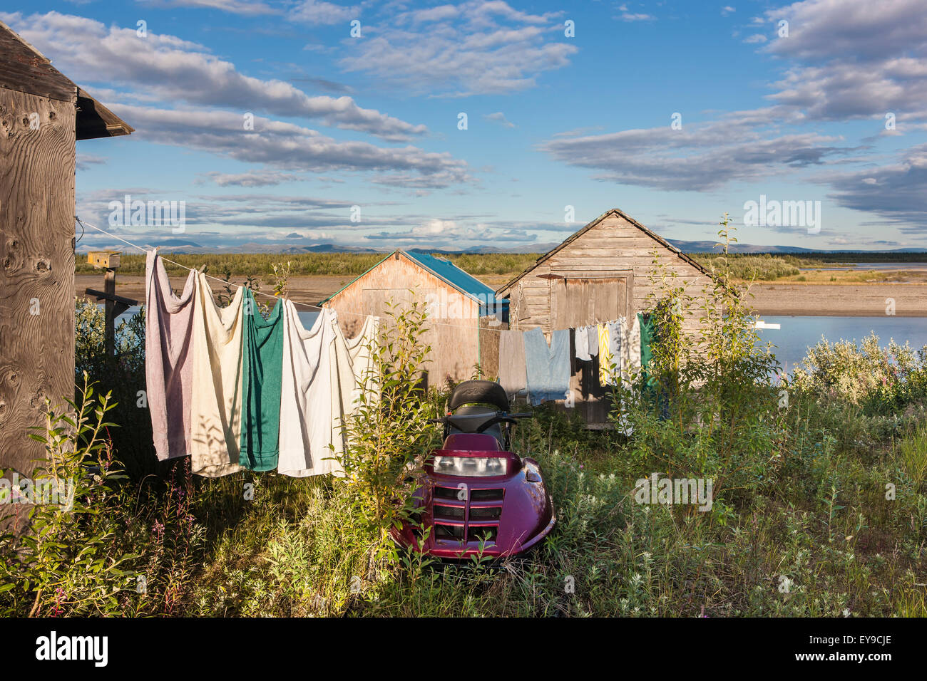 Clothes hang on a clothesline between houses and along the Noatak River ...