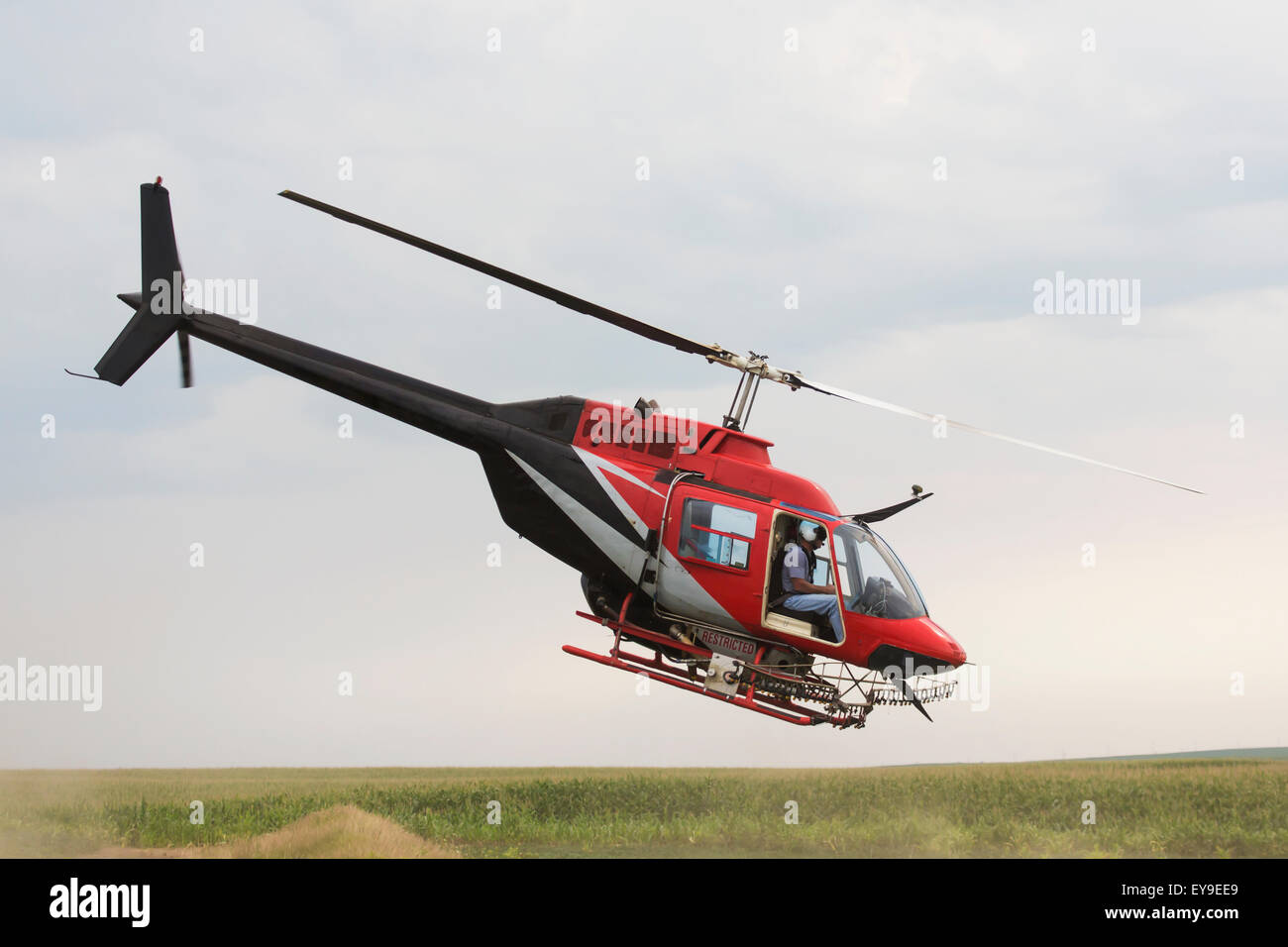 Crop dusting helicopter taking off from refilling for another flight ...