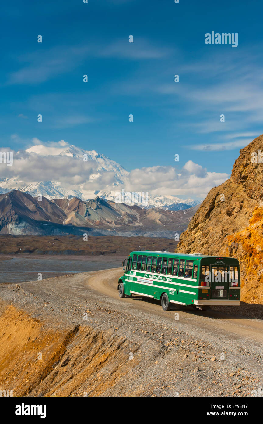 A park bus on the park road with Mount Mckinley in the background ...