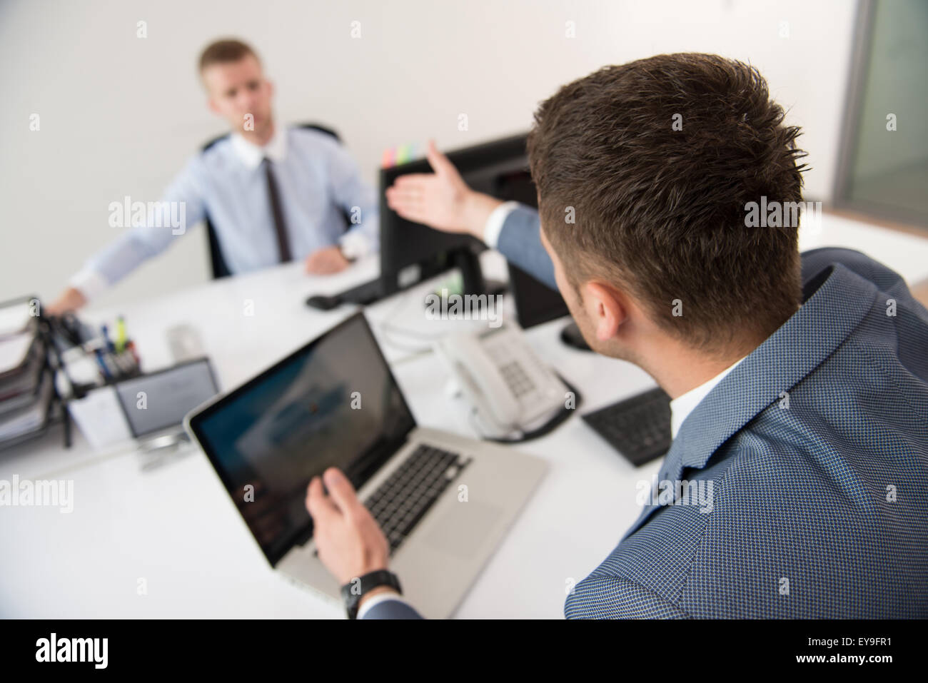 Two Young Businessmen Having An Argument Stock Photo - Alamy