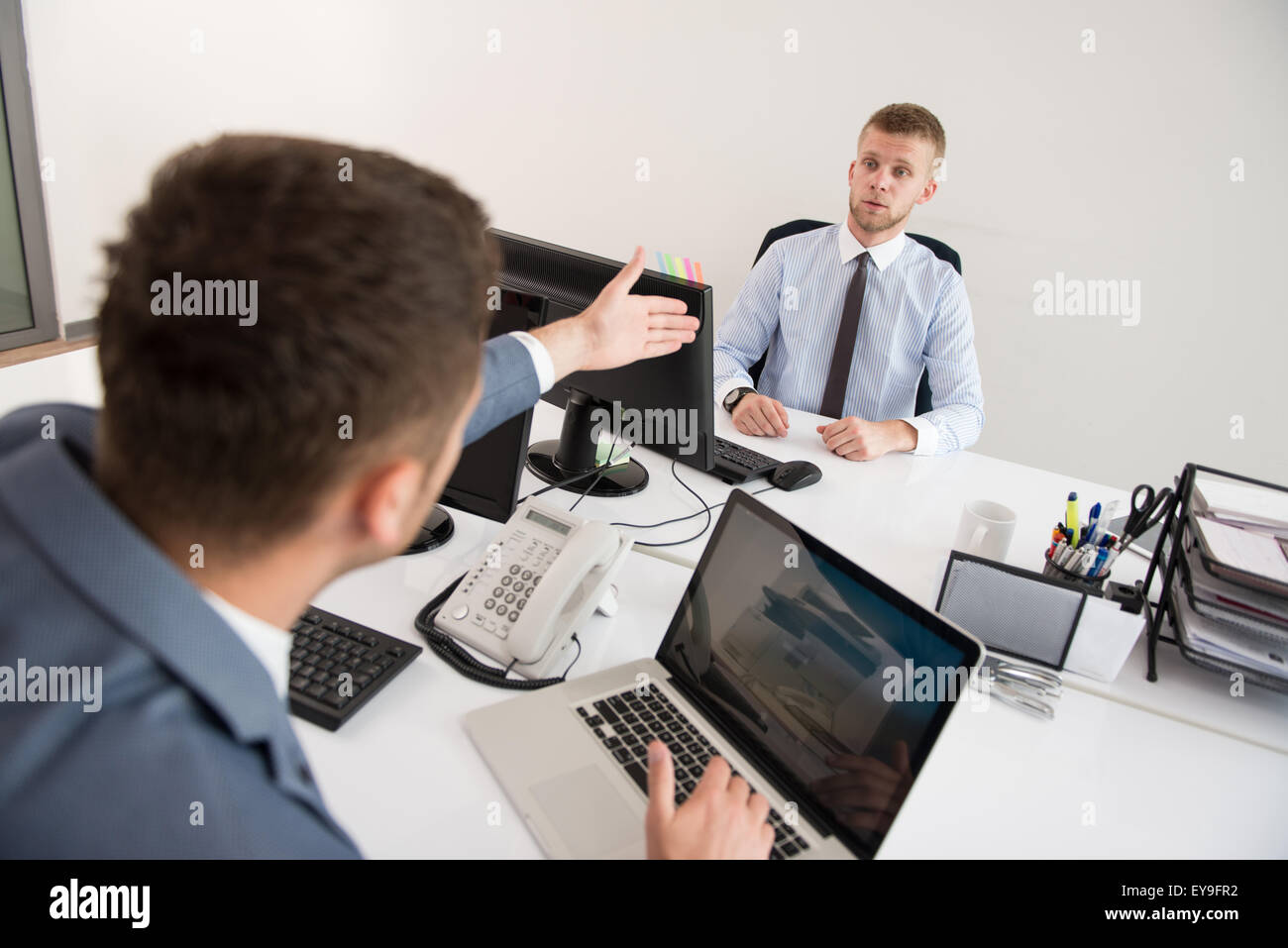 Two Young Businessmen Having An Argument Stock Photo - Alamy