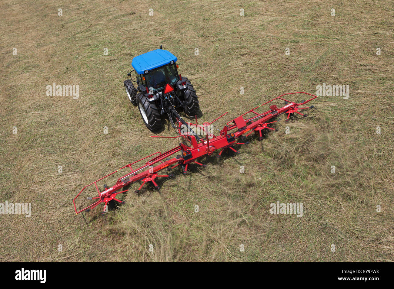 High angle view of New Holland T4050 tractor with H5270 tedder in ...