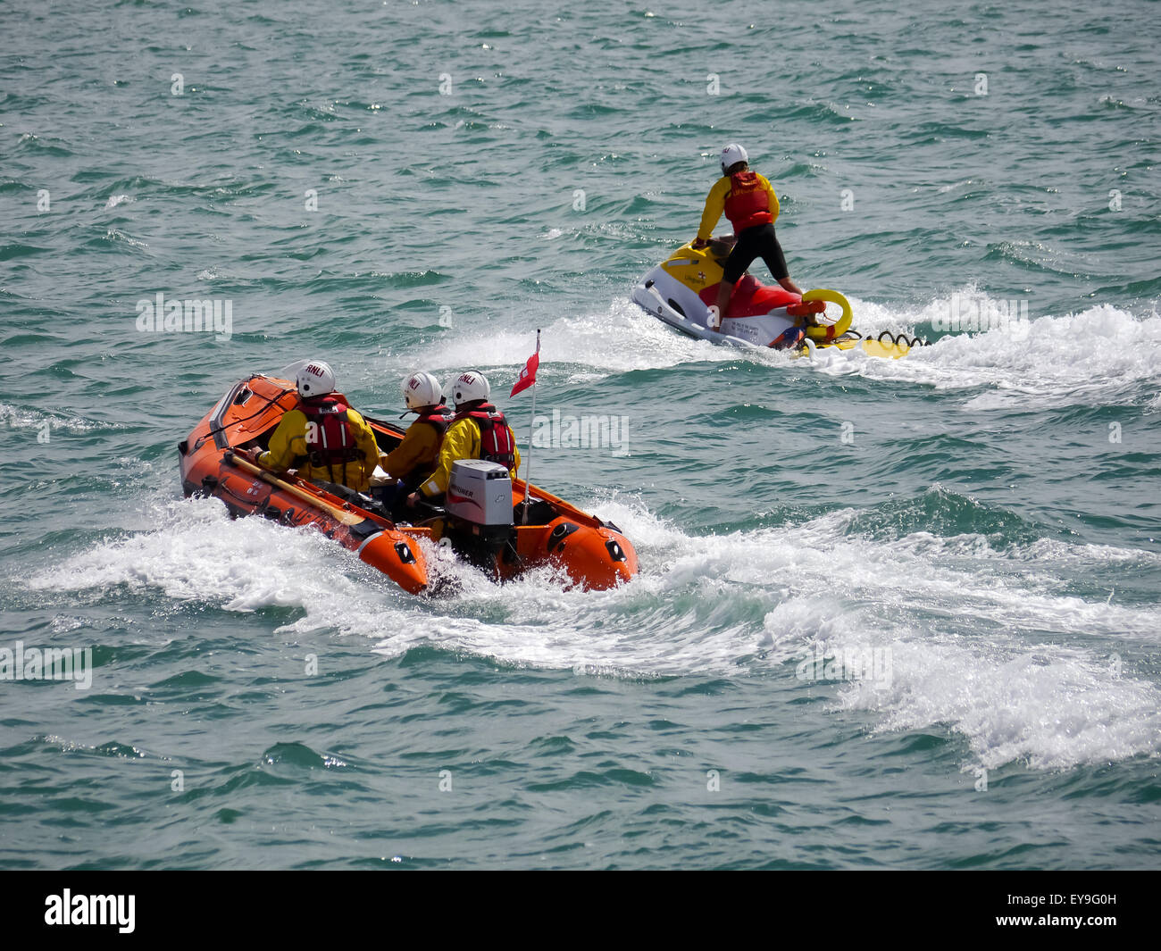 RNLI Lifeguards riding a Rib and a jetski in the sea Stock Photo - Alamy