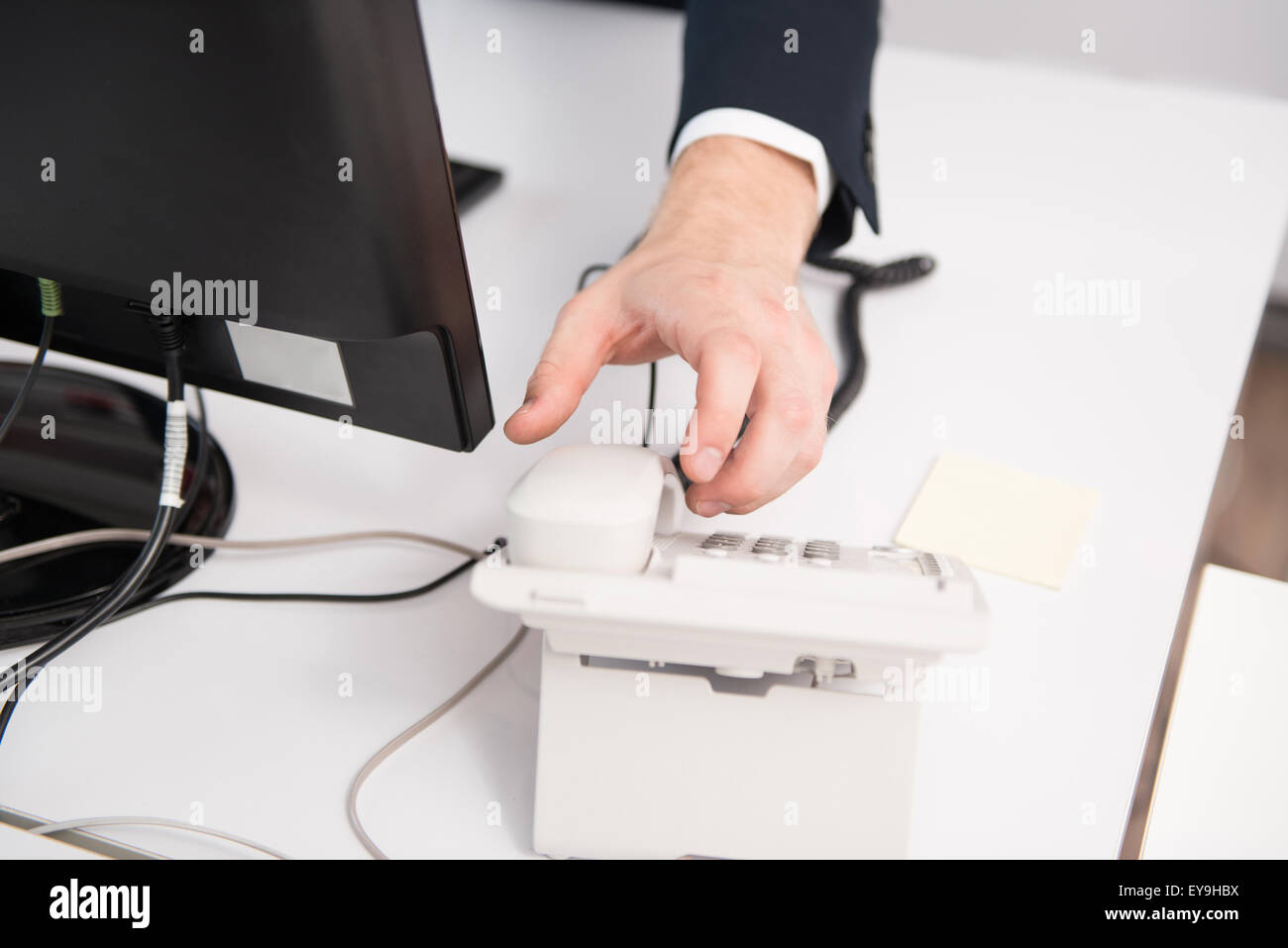 Businessman Pick Up Or Hangs Up The Phone In The Office Stock Photo - Alamy