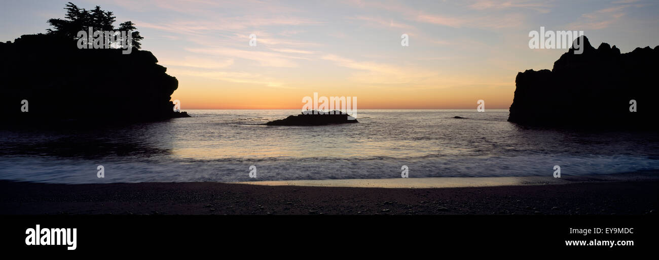 Two Cliffs Lining Beach At Sunset Stock Photo - Alamy