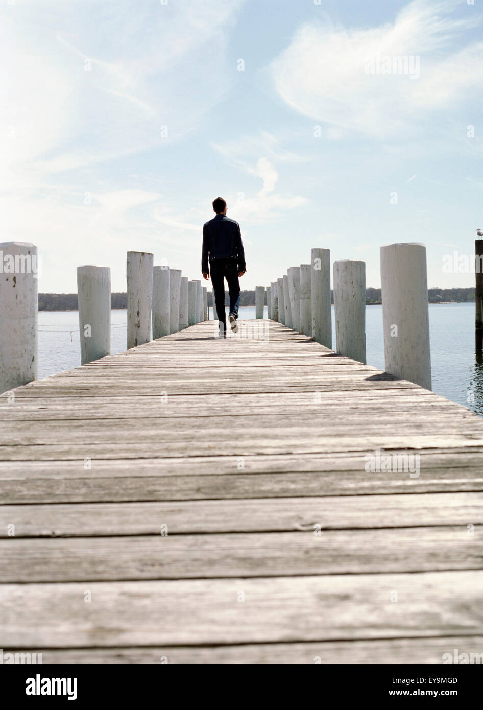 Man Walking Down Pier Stock Photo - Alamy