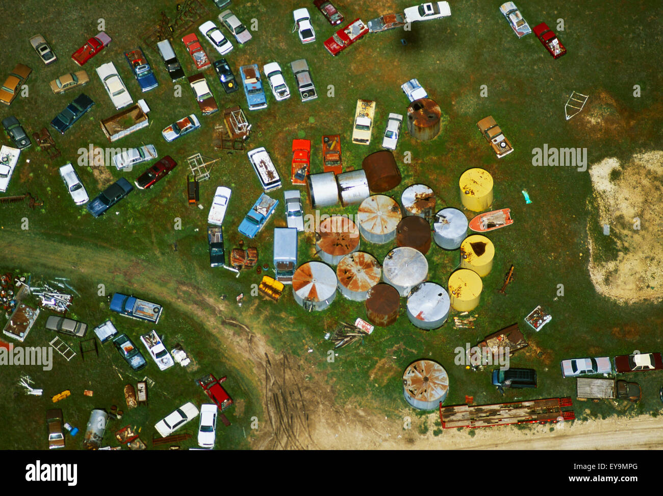 Agriculture - Aerial view of a farm junkyard with old cars, tanks and ...