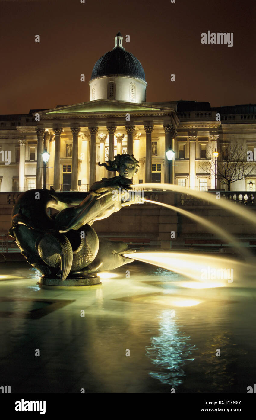 View Of Trafalgar Square At Night With Fountain And National Gallery ...