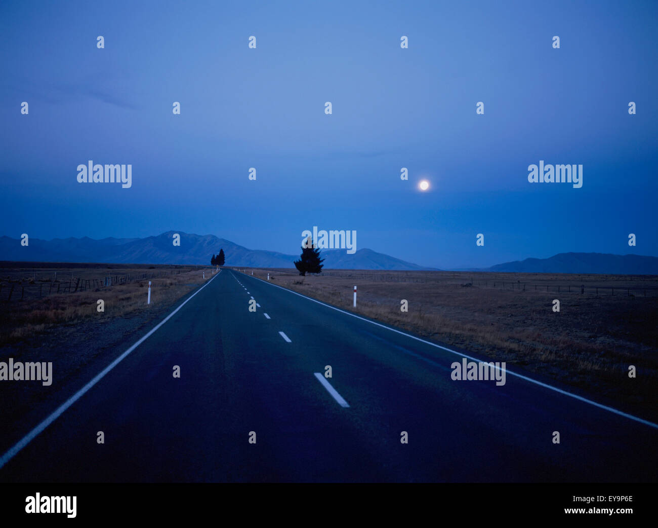 Empty Highway Through Countryside At Night With Moon Stock Photo - Alamy