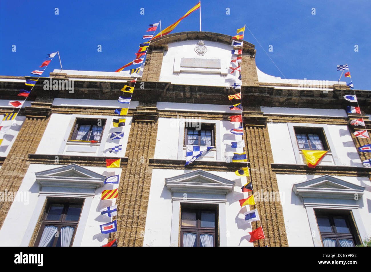 Building With Colorful Flags Stock Photo - Alamy