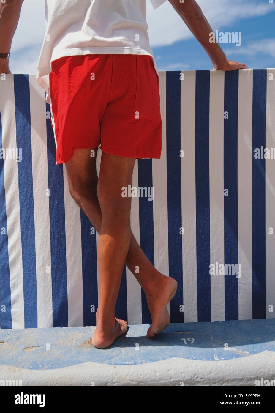 Lifeguard Leaning Against A Wind Break At The Beach Stock Photo - Alamy