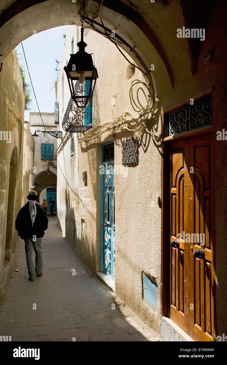Man walking down back alley hi-res stock photography and images - Alamy