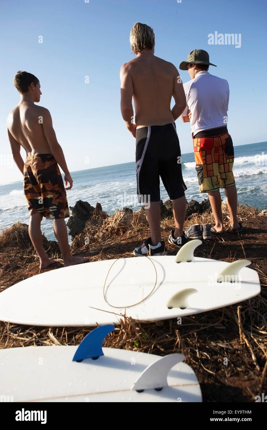 Surfboards On Ground Behind Three Surfers Stock Photo - Alamy