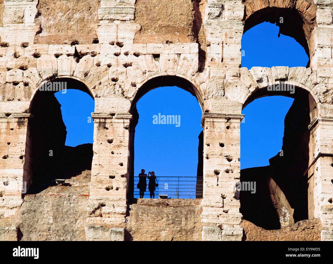 Colloseum With Silhouette Of Two People Stock Photo - Alamy