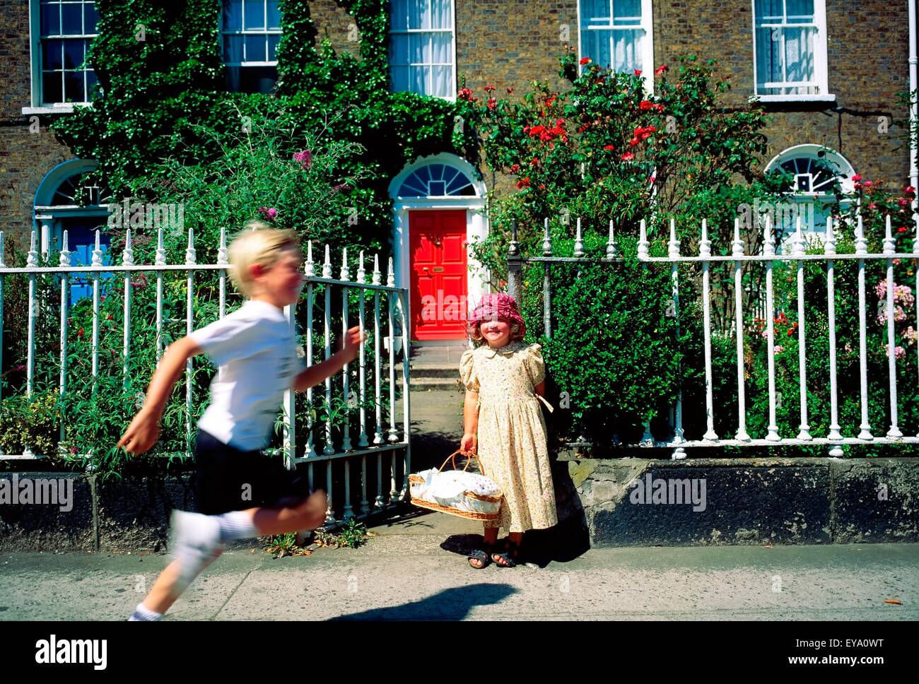 Happy children running front gate hi-res stock photography and images ...