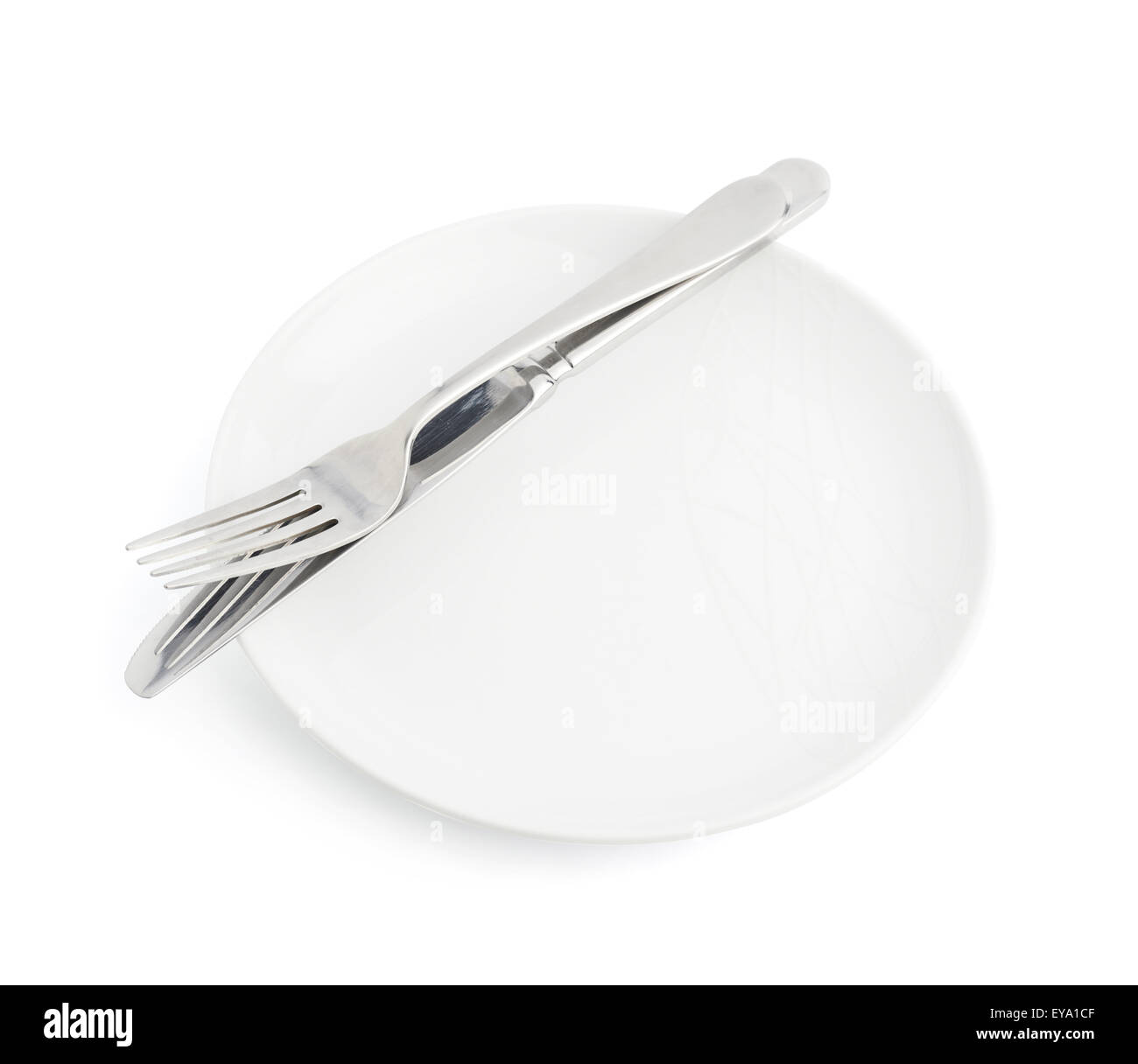 Knife and fork over the plate isolated Stock Photo - Alamy