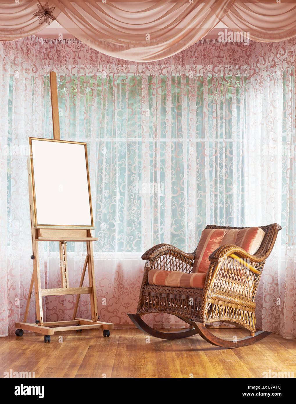 Wooden easel and wicker rocking chair composition Stock Photo - Alamy