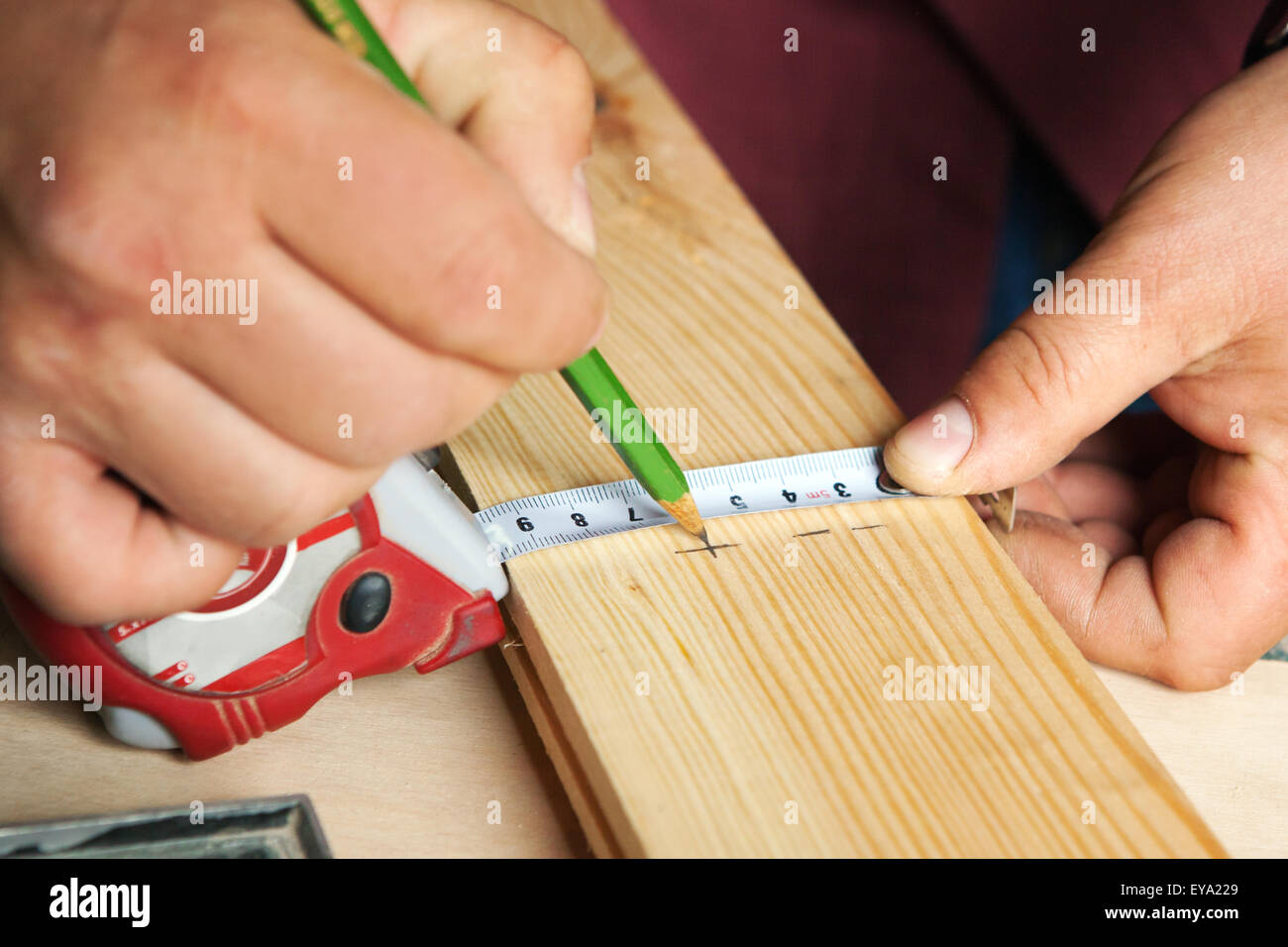 Male hands with ruler and pencil closeup. Professional carpenter at ...
