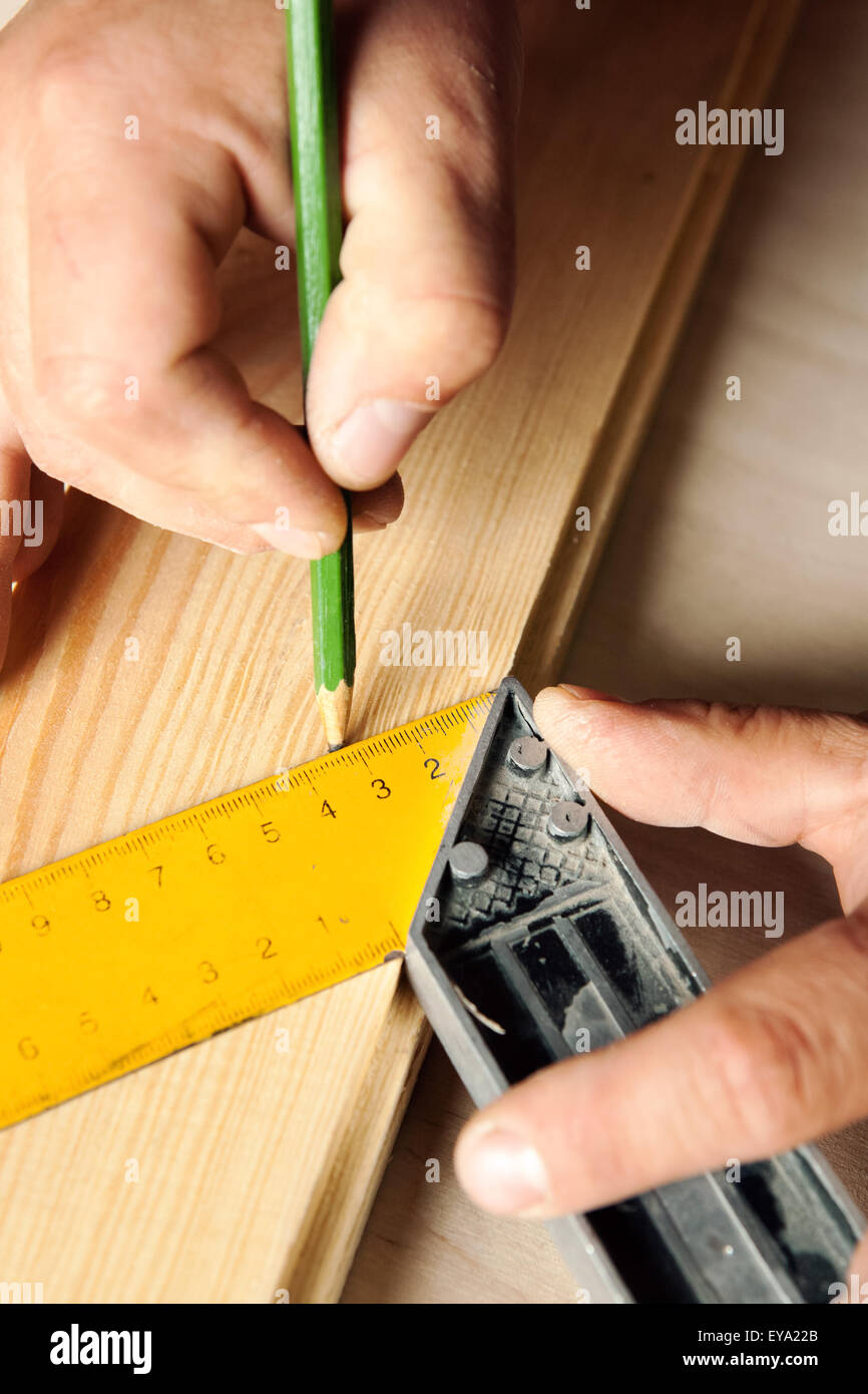 Male hands with ruler and pencil closeup. Professional carpenter at ...