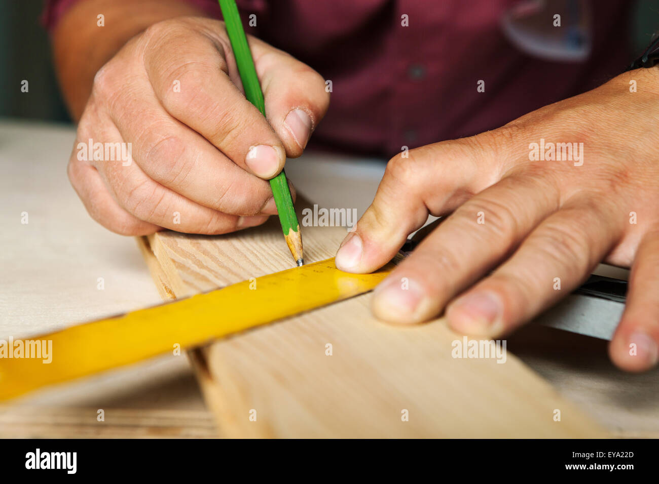 Male hands with ruler and pencil closeup. Professional carpenter at ...