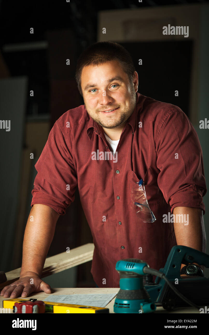 Portrait of happy professional carpenter at his work place Stock Photo ...