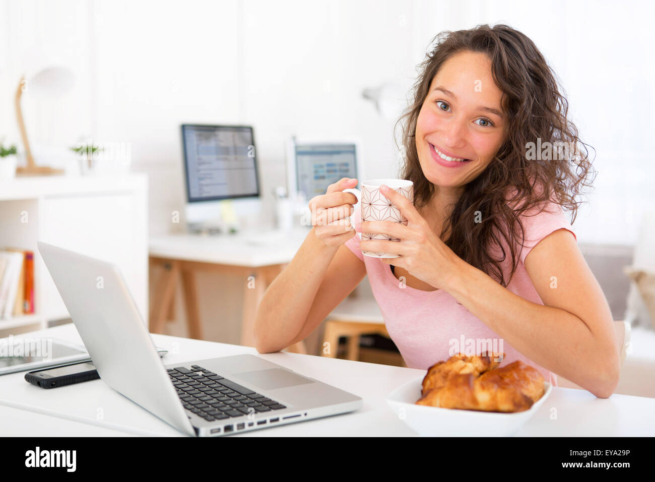 View of a Young attractive student taking breakfast while working Stock ...