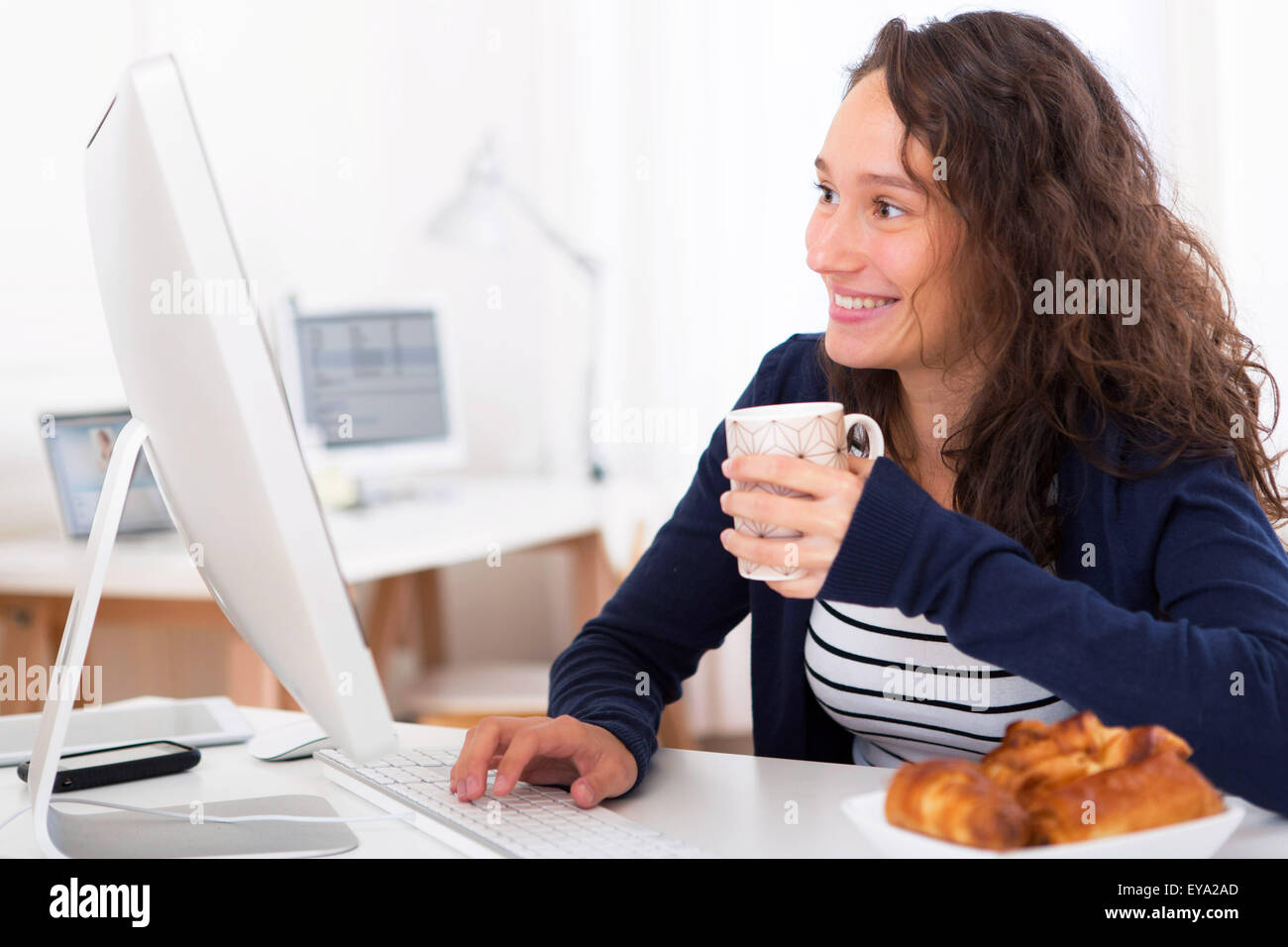 View of a Young attractive student taking breakfast while working Stock ...