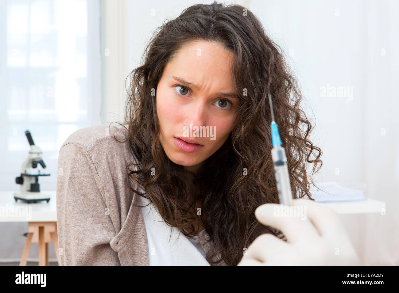 View of an Attractive young woman scared by injection Stock Photo - Alamy